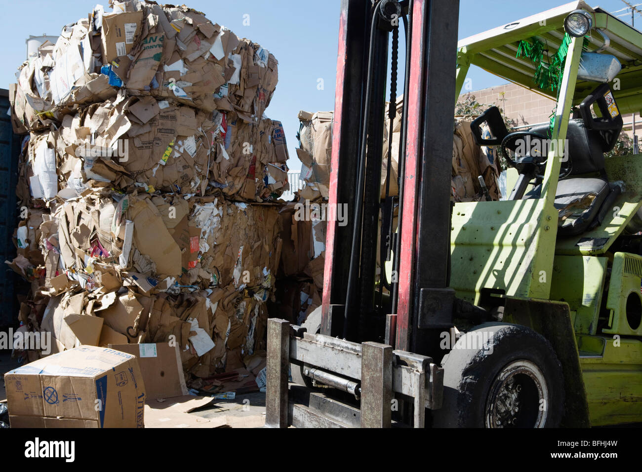 Stacks of cardboard boxes in recycling centre and forklift truck Stock ...