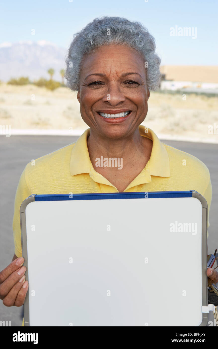 Portrait of woman holding sign outdoors Stock Photo - Alamy