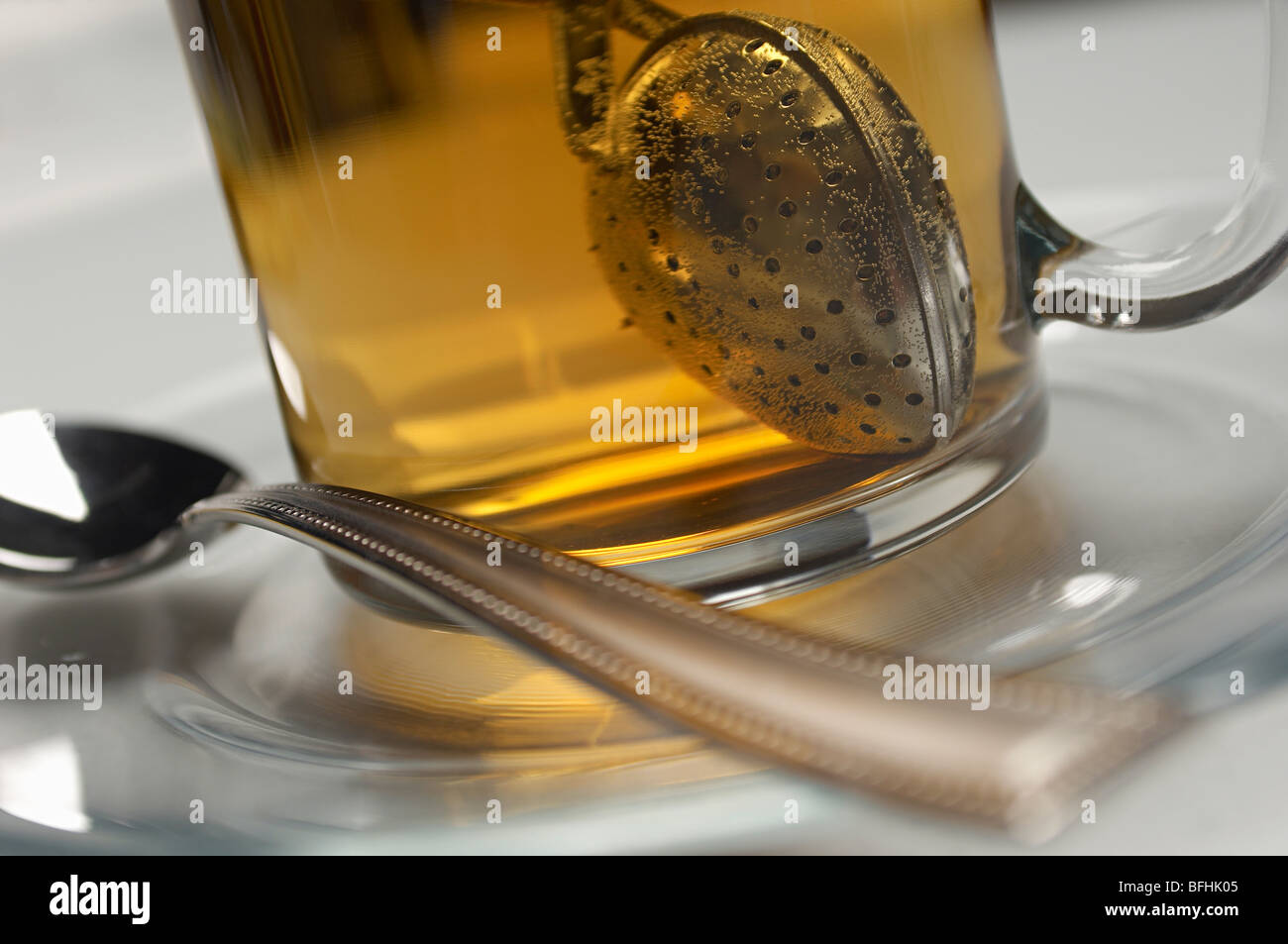 Glass with tea strainer inside, close-up Stock Photo - Alamy