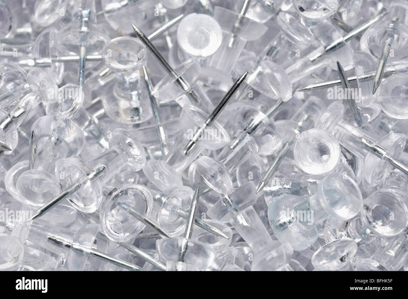 Heap of transparent thumbtacks Stock Photo - Alamy