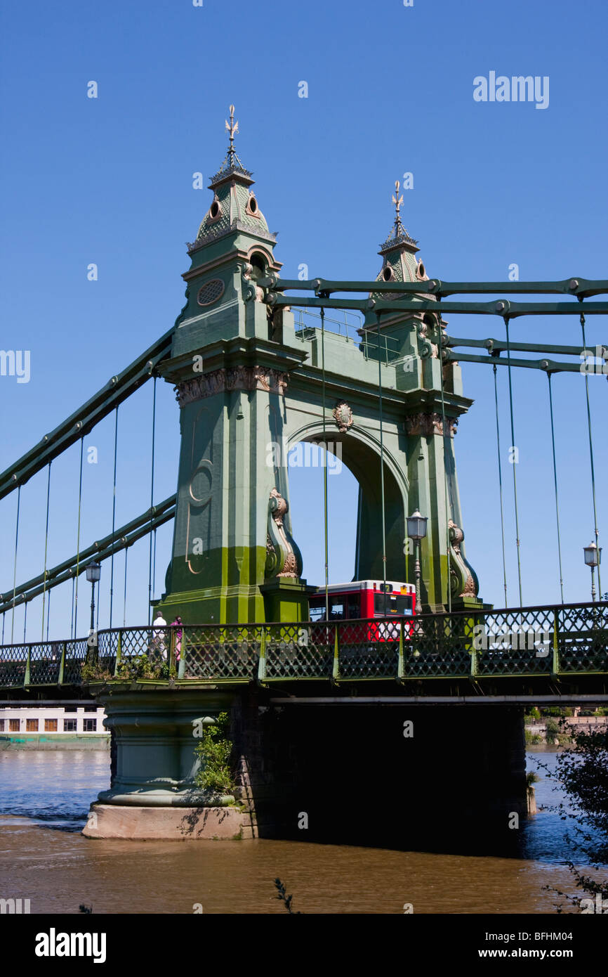 Single decker red London bus crosses Hammersmith Bridge on a sunny ...
