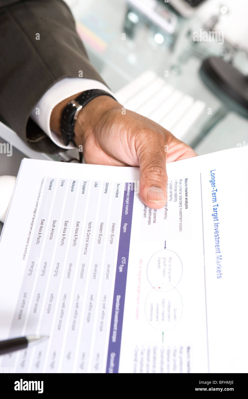 Man Looking at Paper Stock Photo - Alamy