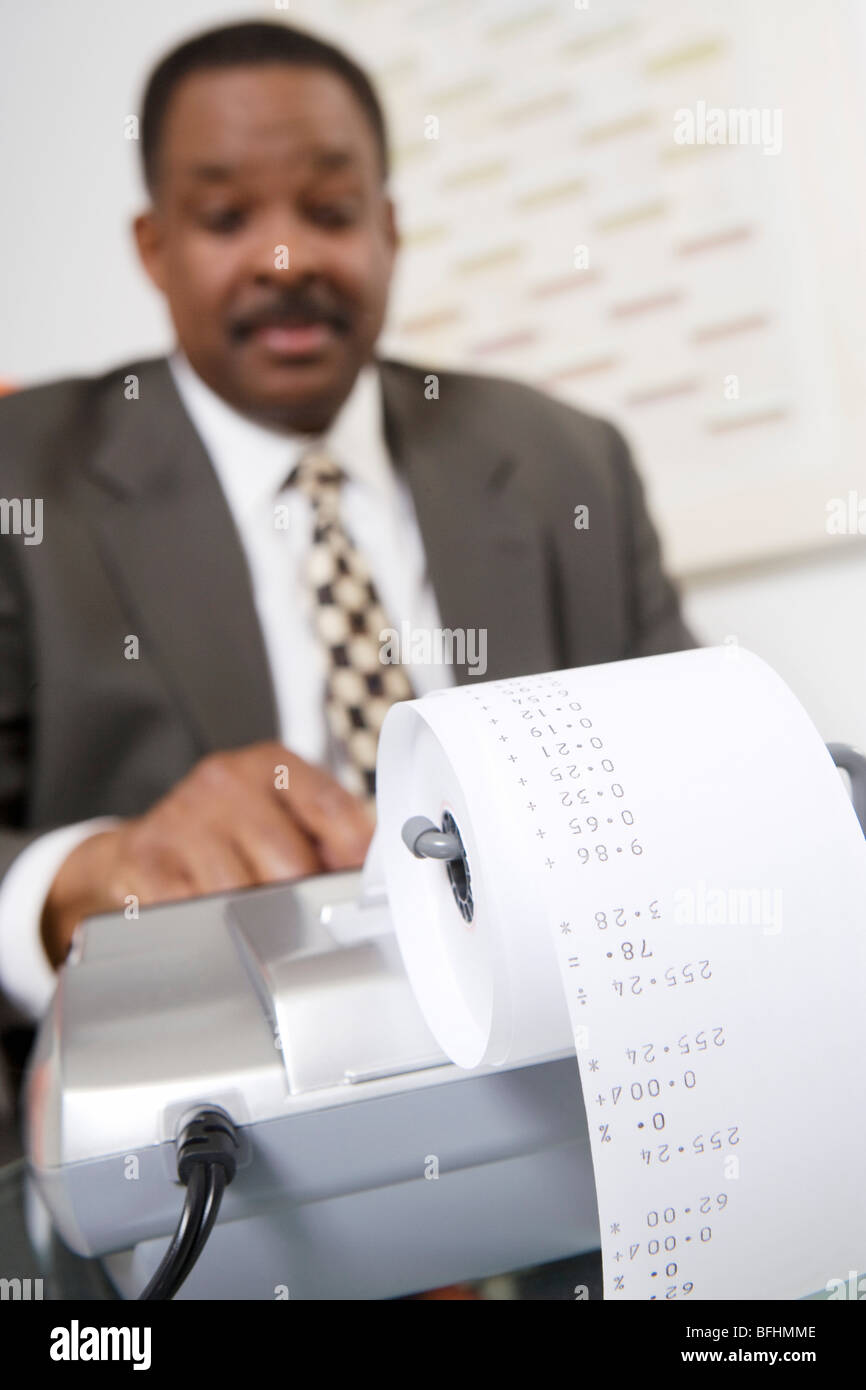 Businessman Using an Adding Machine Stock Photo - Alamy