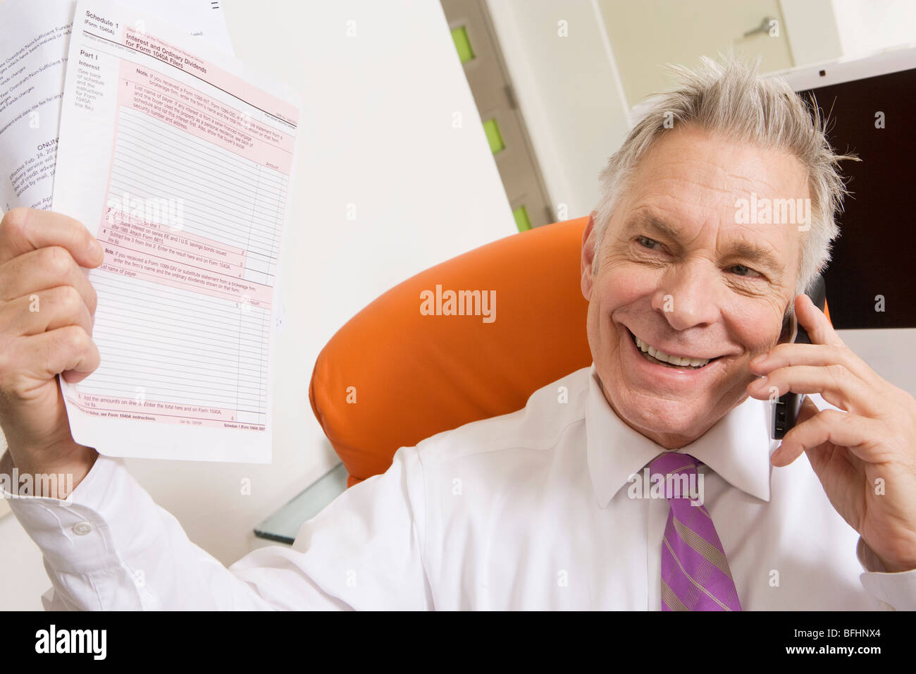 Businessman Holding Tax Forms Stock Photo - Alamy