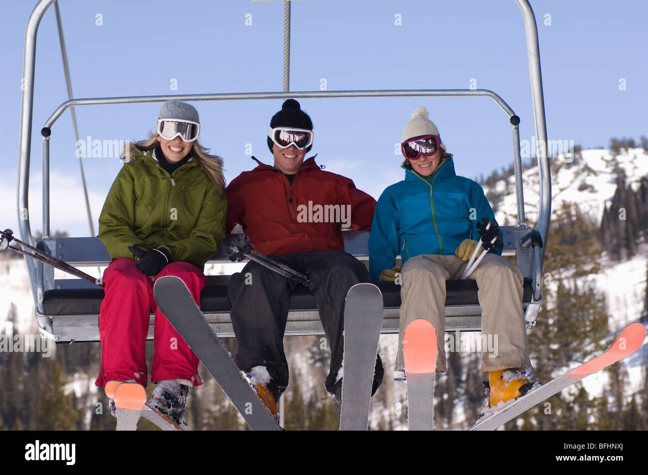 Three Skiers on Chair Lift Stock Photo - Alamy
