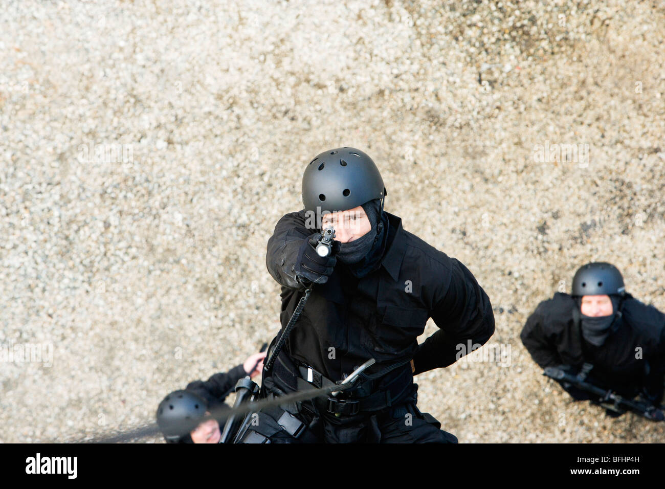SWAT Team Officer Rappelling and Aiming Gun Stock Photo - Alamy
