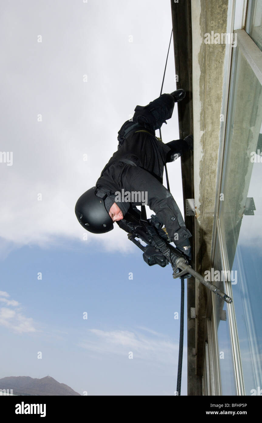 SWAT Team Officer Rappelling from Building Stock Photo - Alamy