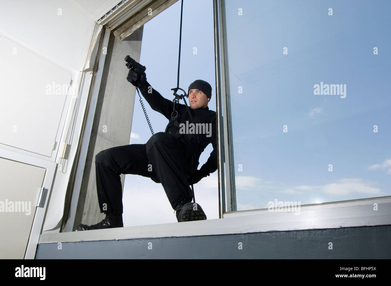 SWAT Team Officer Hanging from Window Stock Photo - Alamy