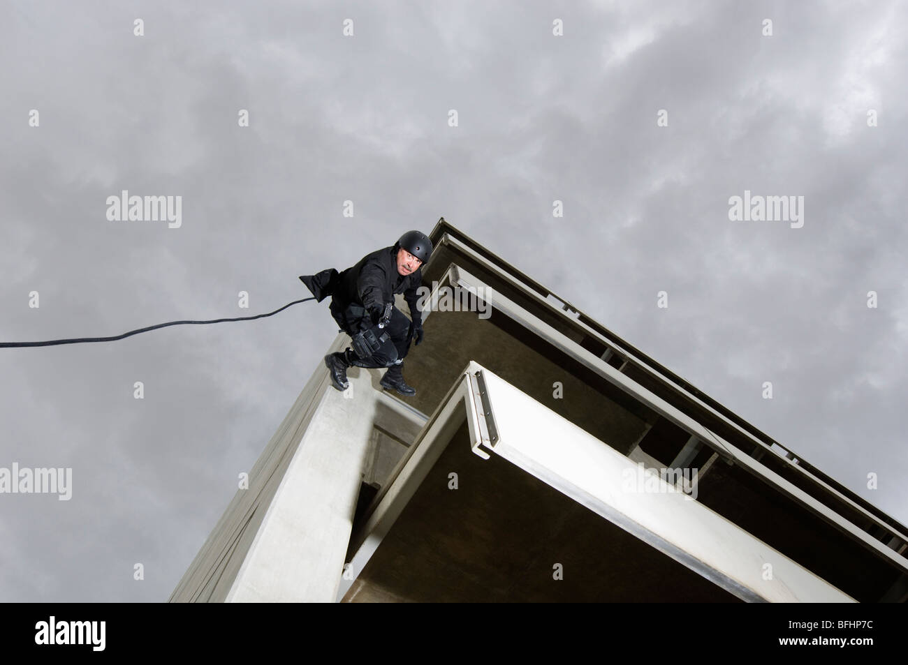 SWAT Team Officer Rappelling and Aiming Gun Stock Photo - Alamy
