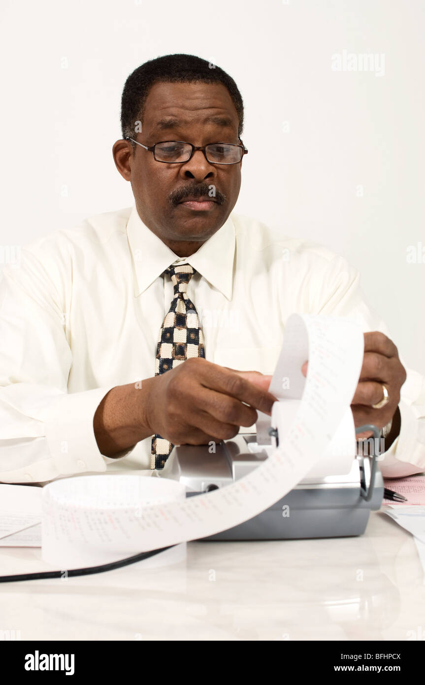 Accountant Reading Adding Machine Tape Stock Photo - Alamy