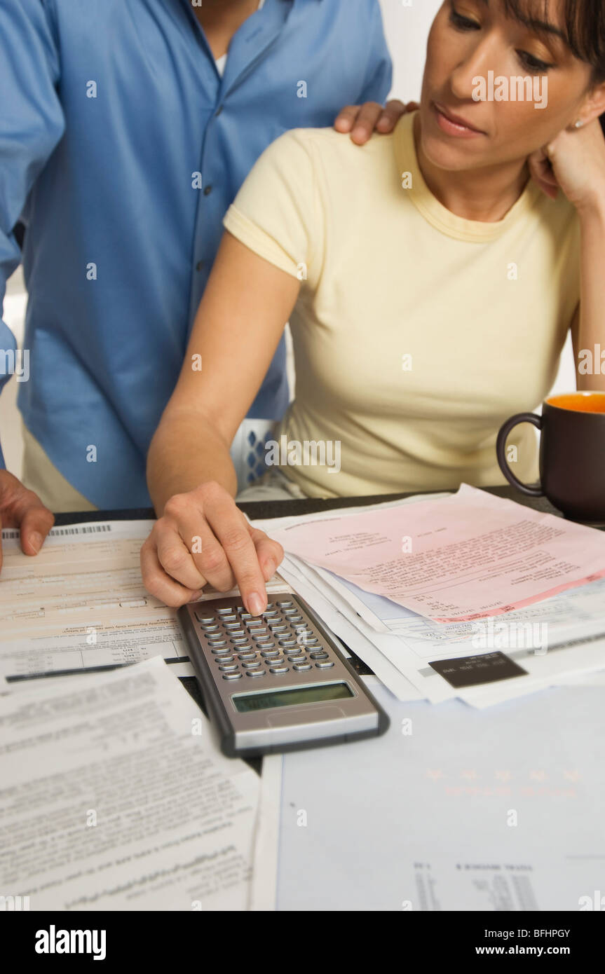 Couple Figuring out Bills Stock Photo - Alamy
