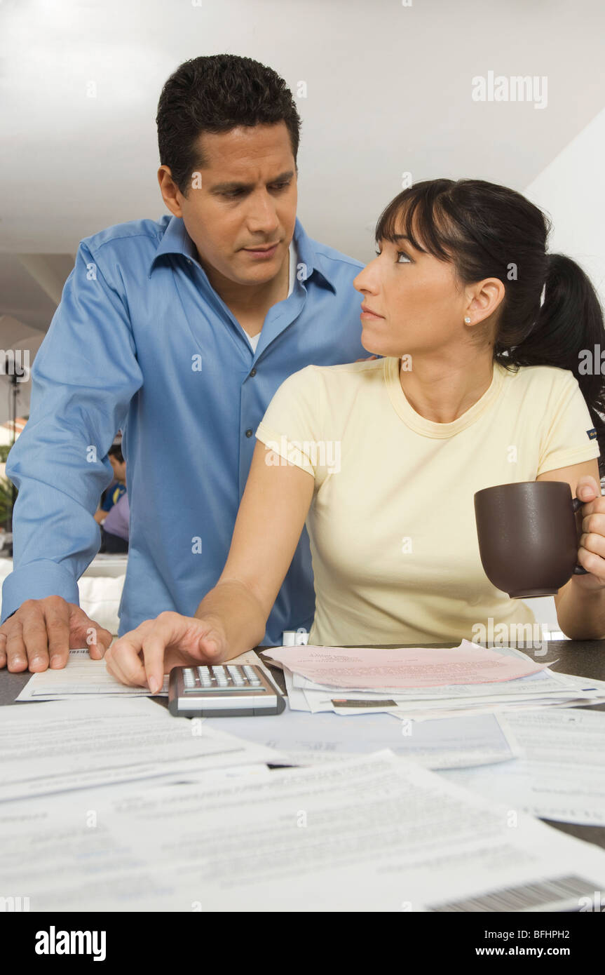 Couple Working on Bills Stock Photo - Alamy