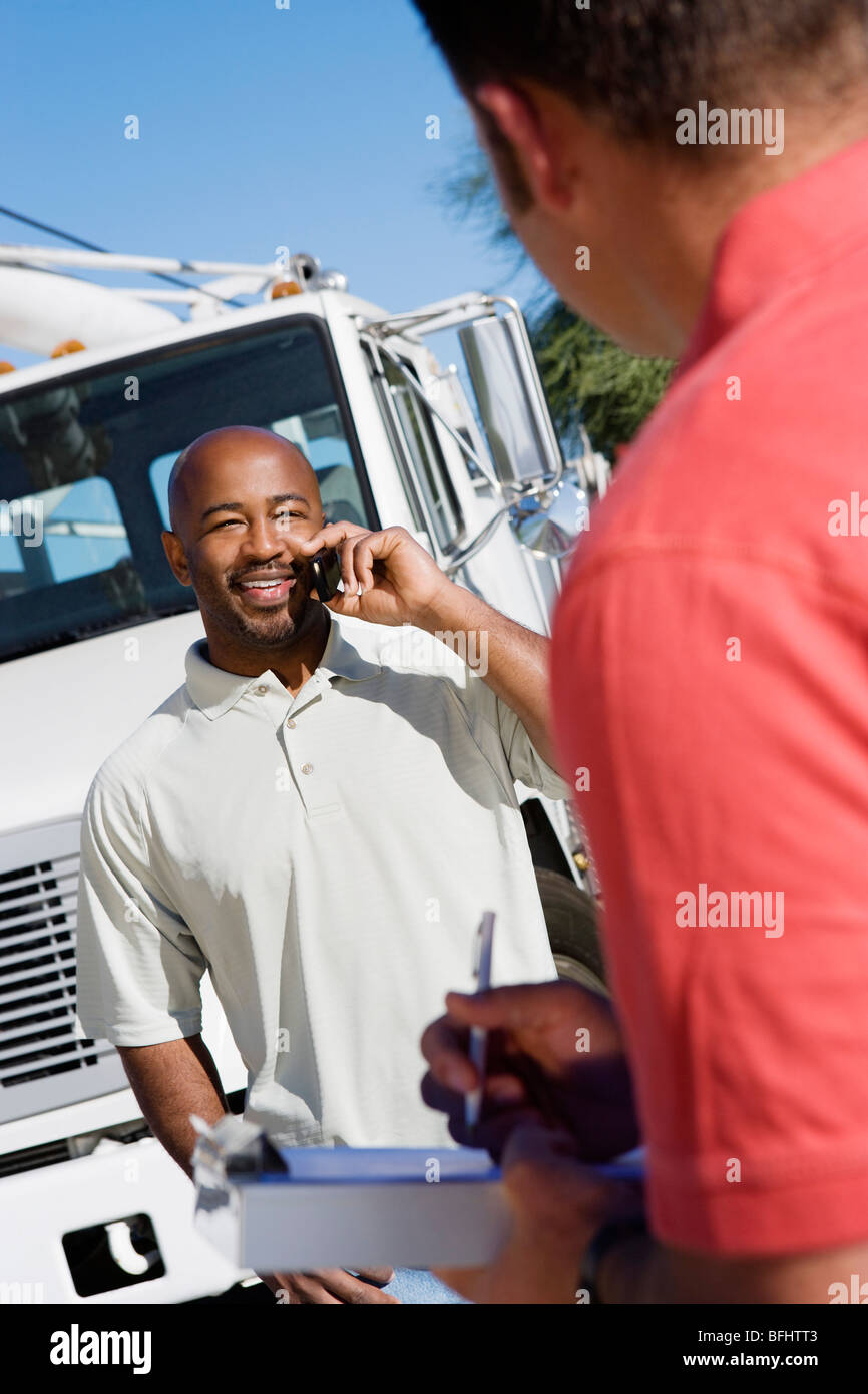 Mid-adult truck driver with co-worker Stock Photo - Alamy