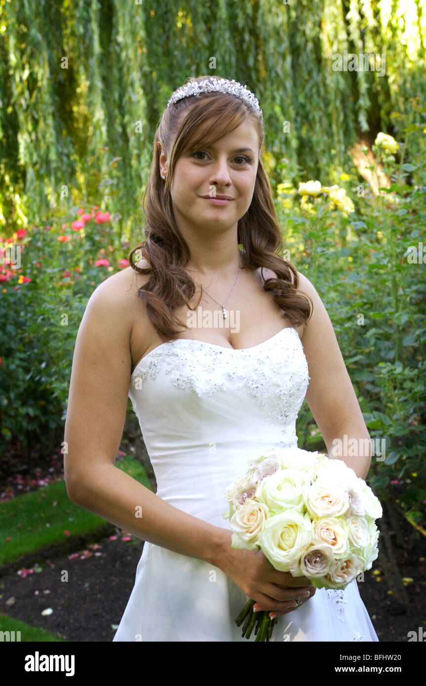 bride standing alone holding wedding bouquet Stock Photo - Alamy
