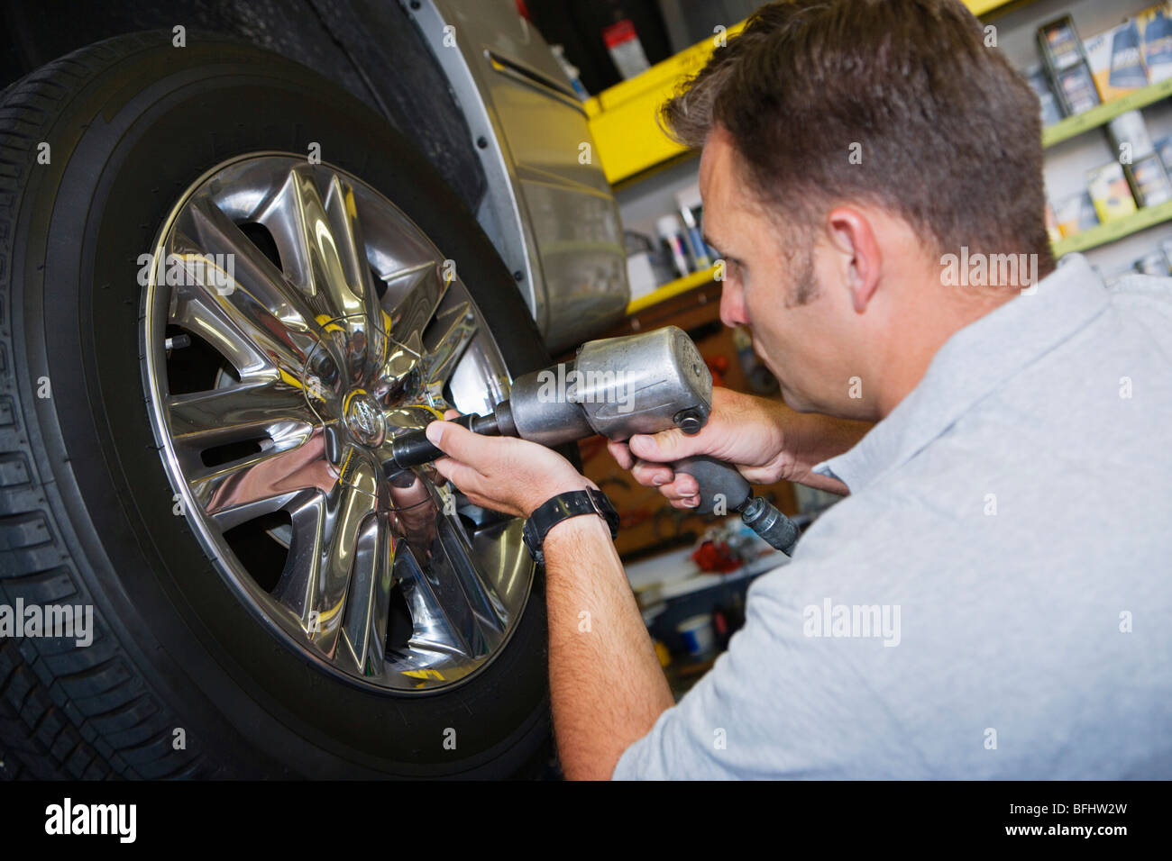 Mechanic Putting Tire on a Car Stock Photo - Alamy