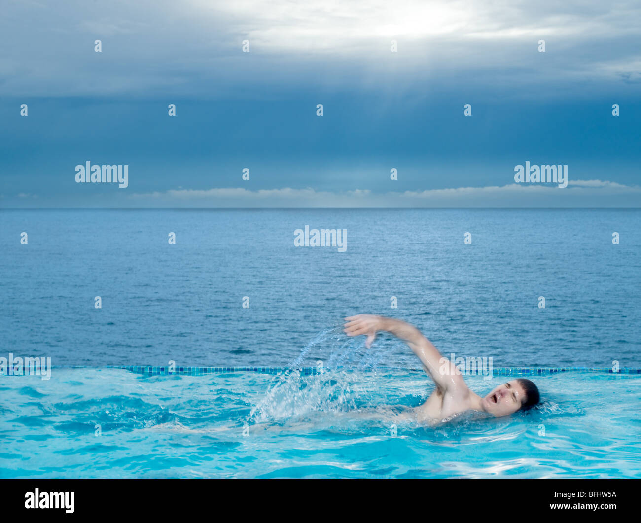 man swimming in a beautiful swimming pool by the seaside Stock Photo ...