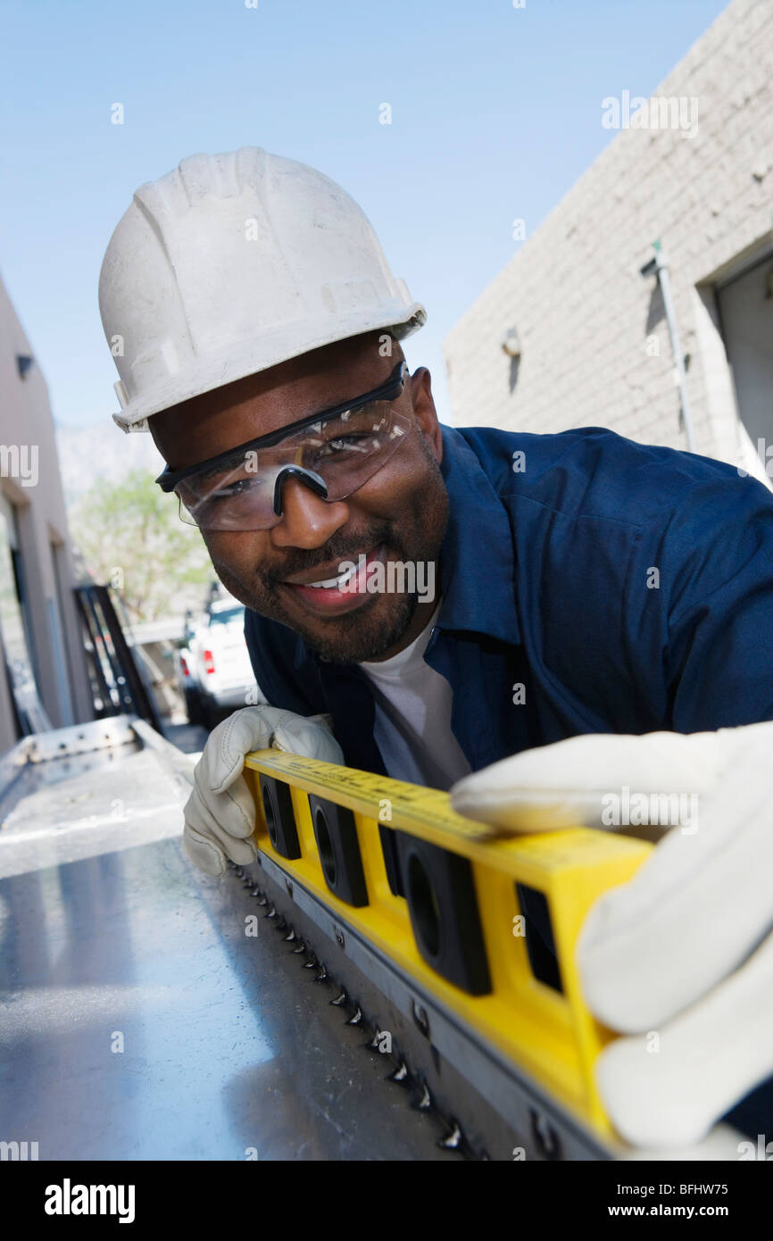 Workman Using a Level Stock Photo - Alamy