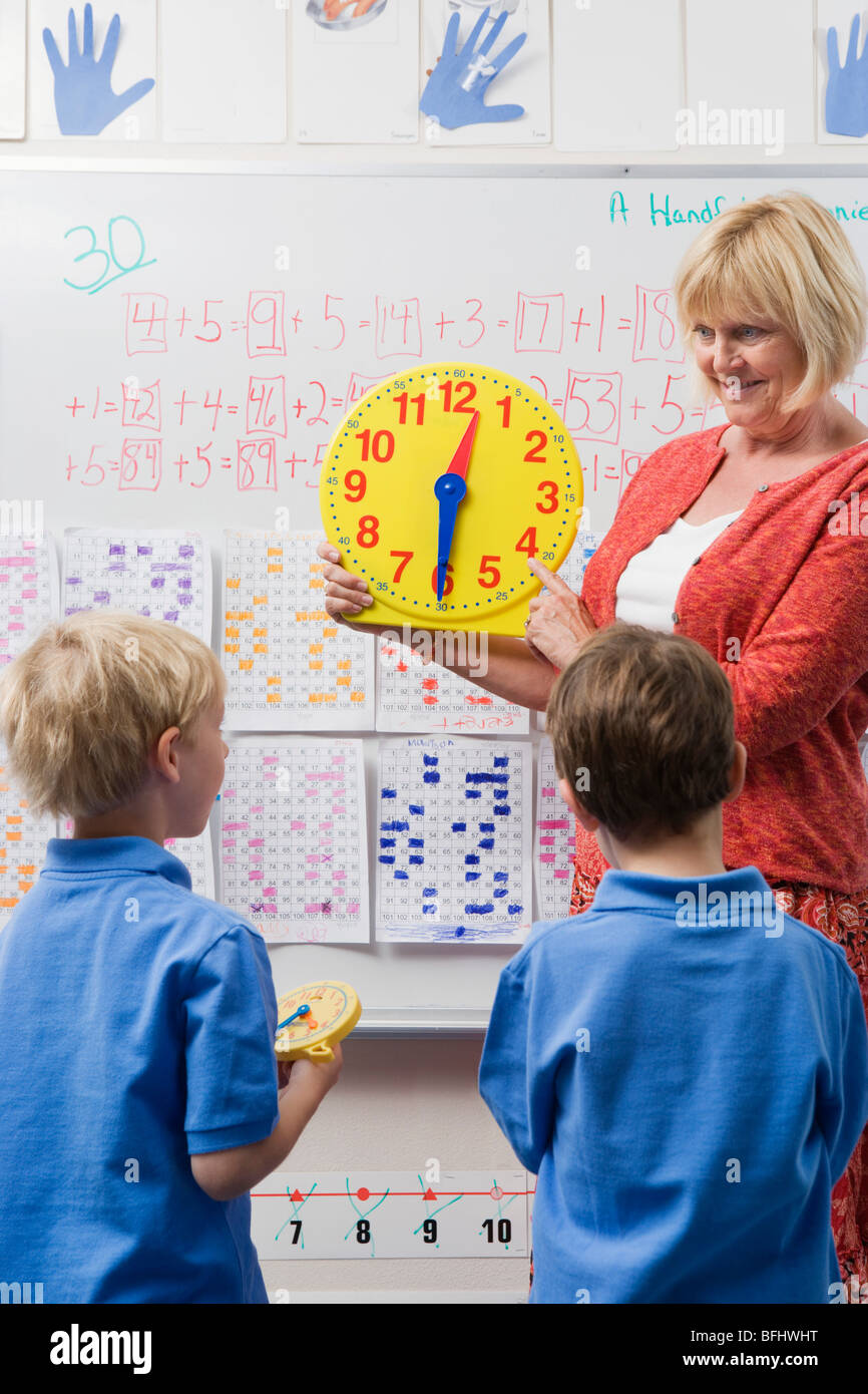Teacher Teaching Kids to Tell Time Stock Photo - Alamy