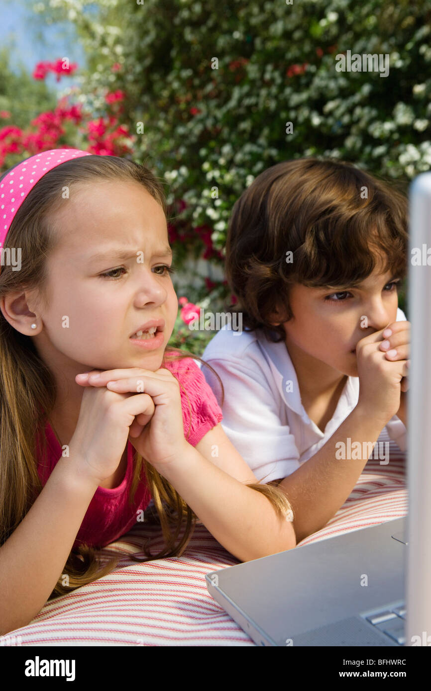 Little Kids Looking at a Laptop Stock Photo - Alamy