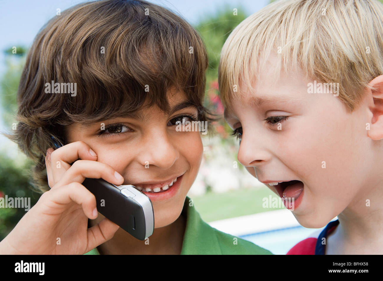 Young Boys Using Cell Phone Stock Photo - Alamy