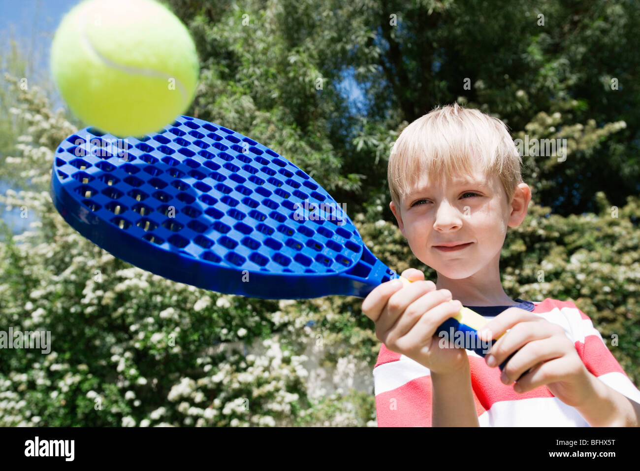 Boy Playing with Paddle and Ball Stock Photo - Alamy