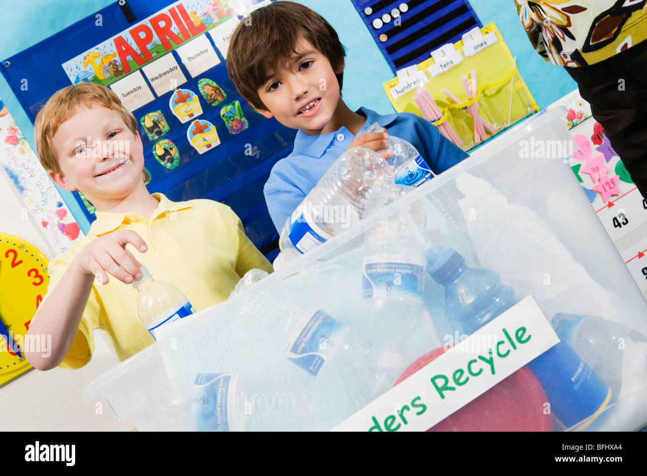 Elementary Students with Recycling Container Stock Photo - Alamy