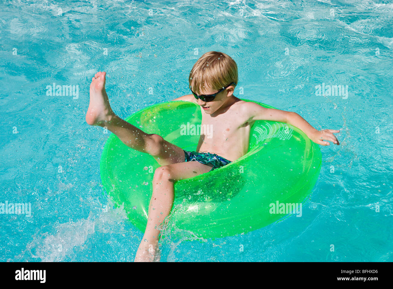 Boy on Float Tube in Swimming Pool Stock Photo - Alamy