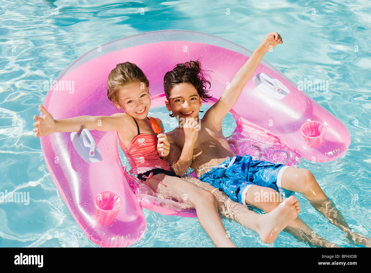 Children Playing on Inflatable Toy in Swimming Pool Stock Photo - Alamy