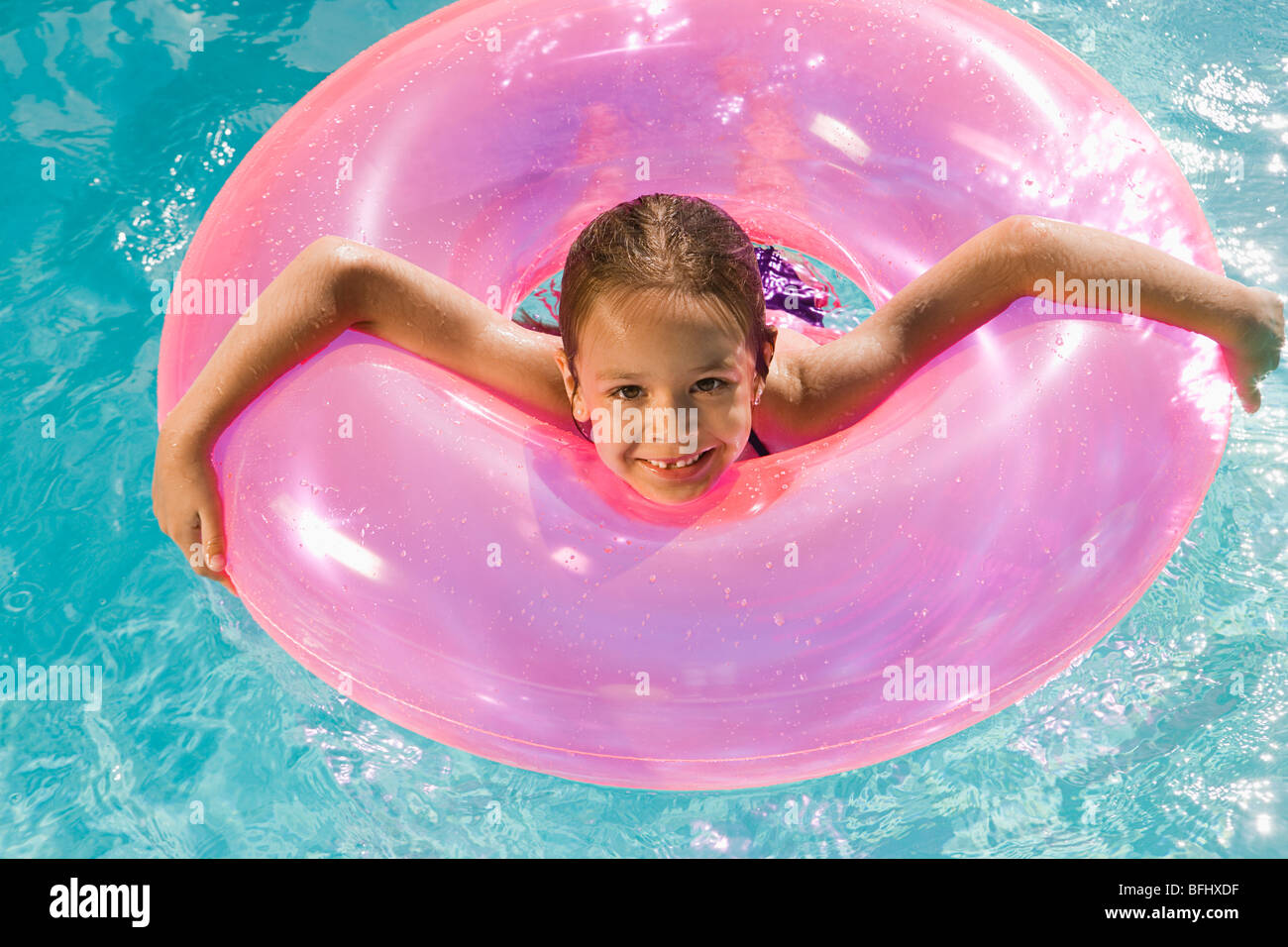Girl Inside Pink Float Tube in Pool Stock Photo - Alamy