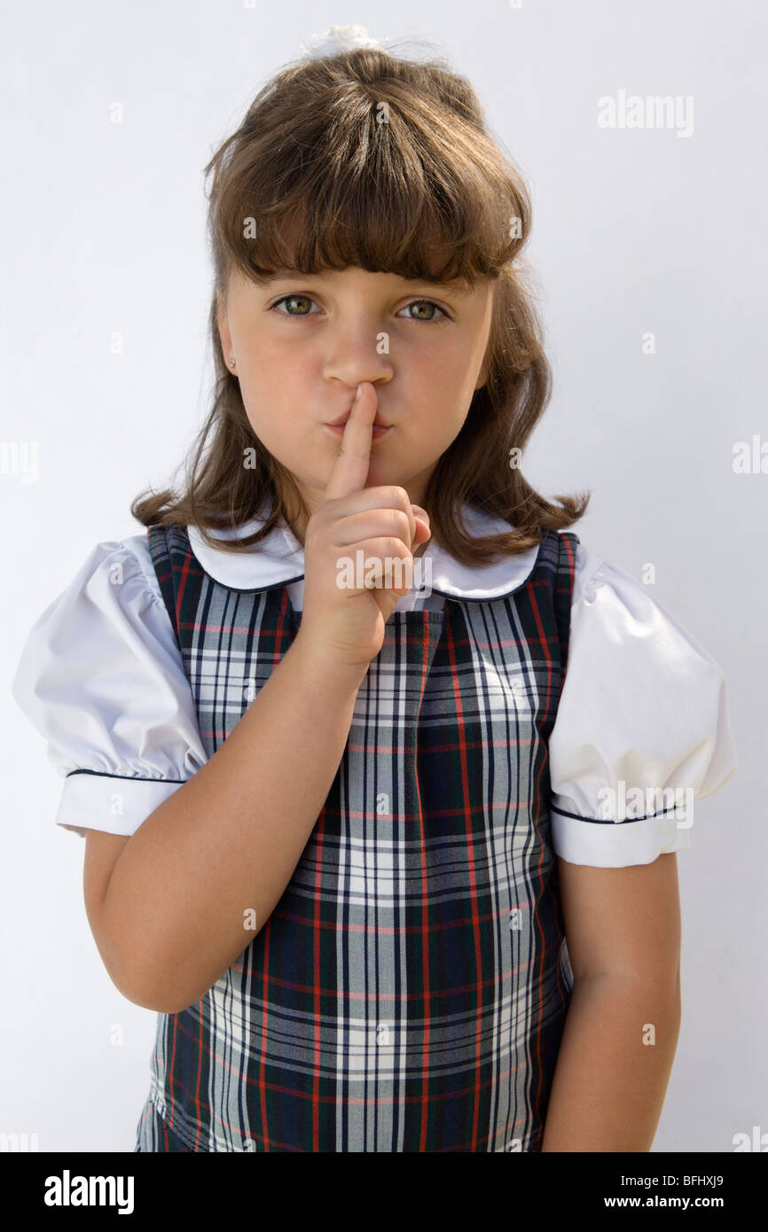 Elementary Student with Finger on Lips Stock Photo - Alamy