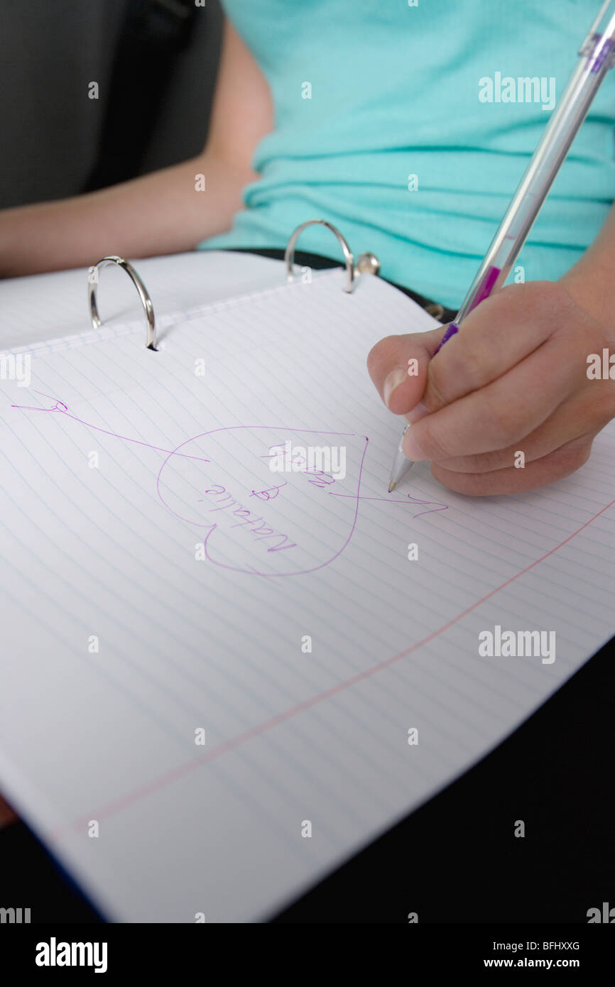 Girl Drawing Heart Shape with Crush's Name Stock Photo - Alamy