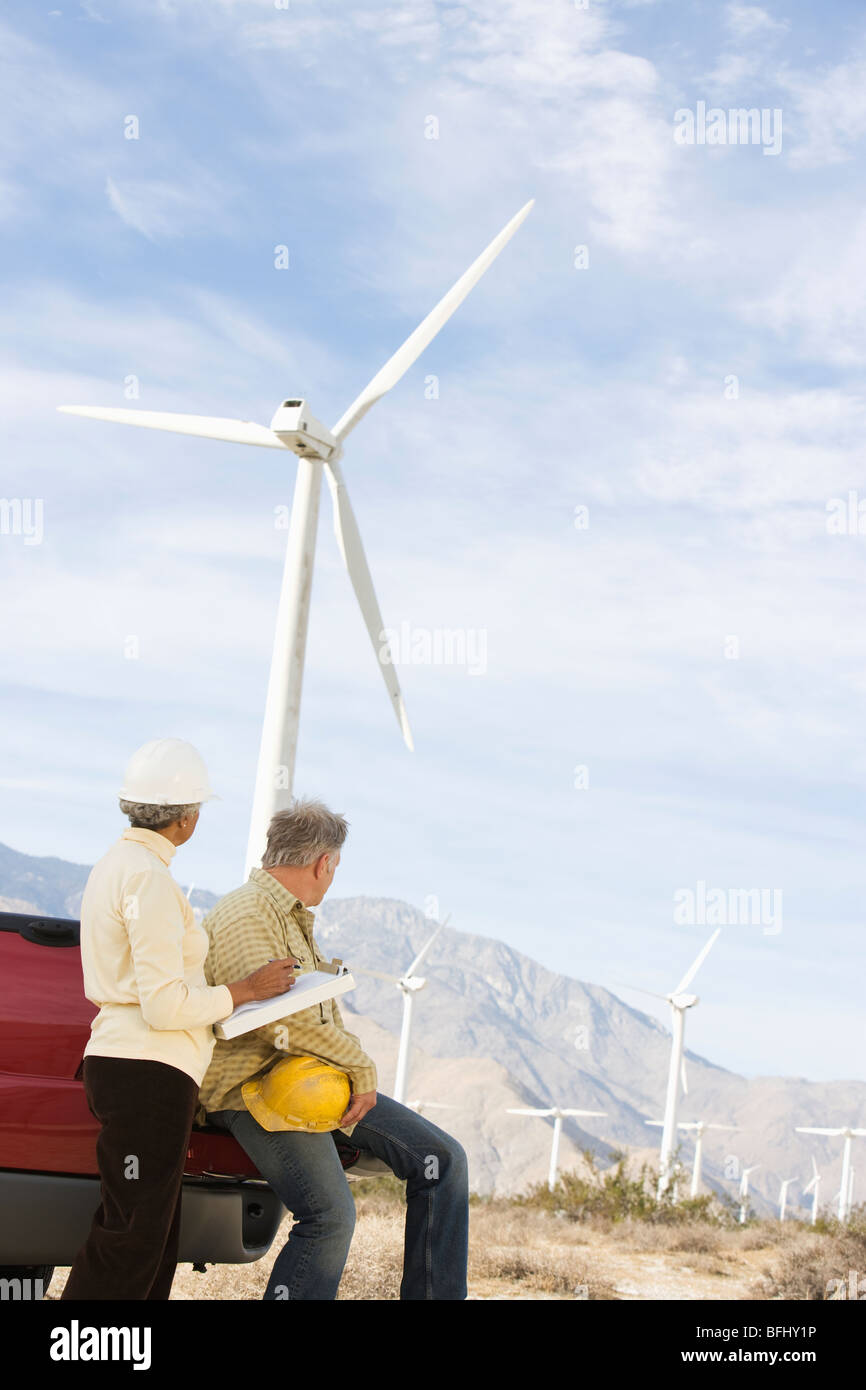 Couple looking at wind farm Stock Photo - Alamy