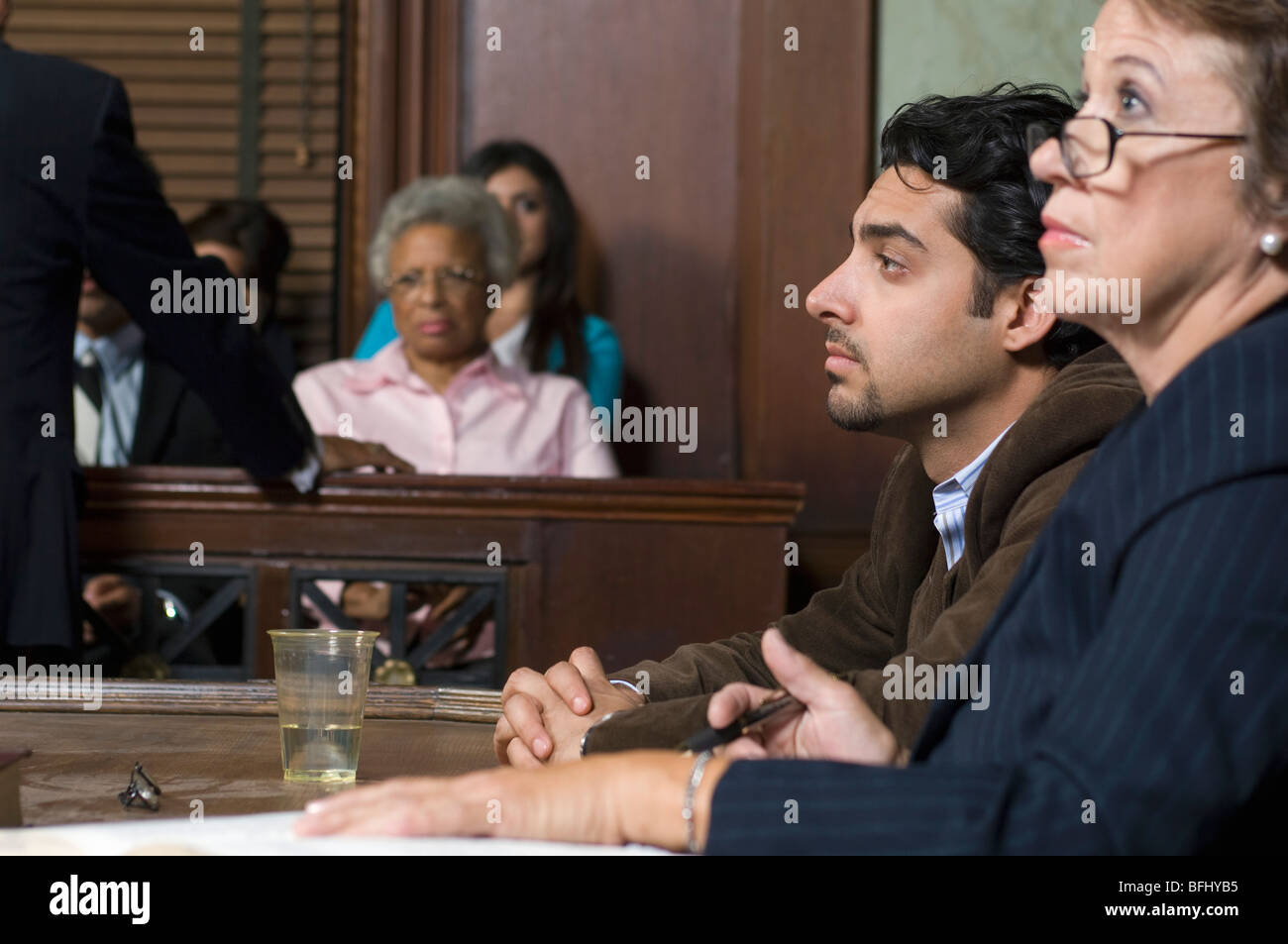 Defense lawyer with client in court Stock Photo - Alamy
