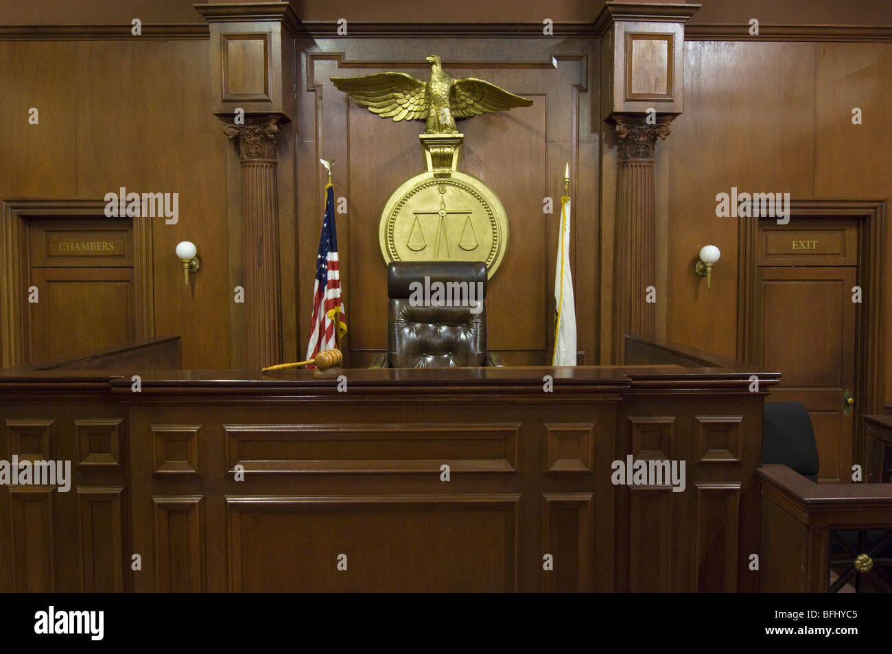 Legal scales behind judges chair in court Stock Photo - Alamy