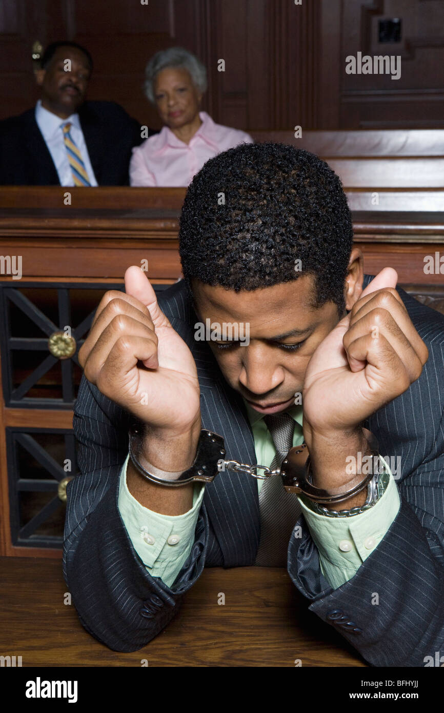 Criminal sitting in court Stock Photo - Alamy