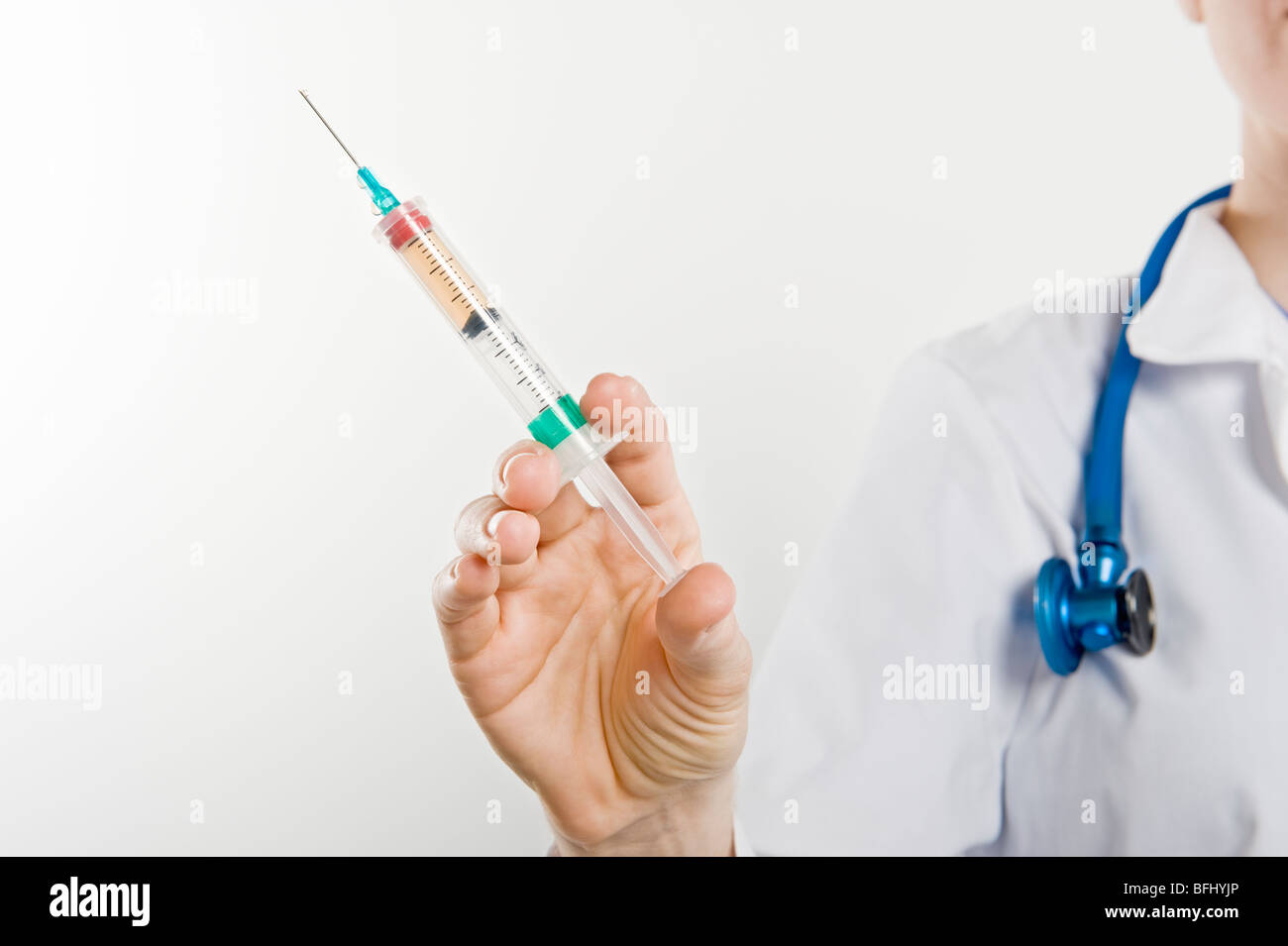 Doctor with syringe, mid section Stock Photo - Alamy