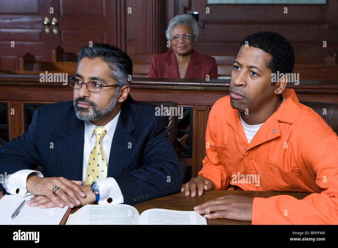 Lawyer and criminal sitting in court Stock Photo - Alamy