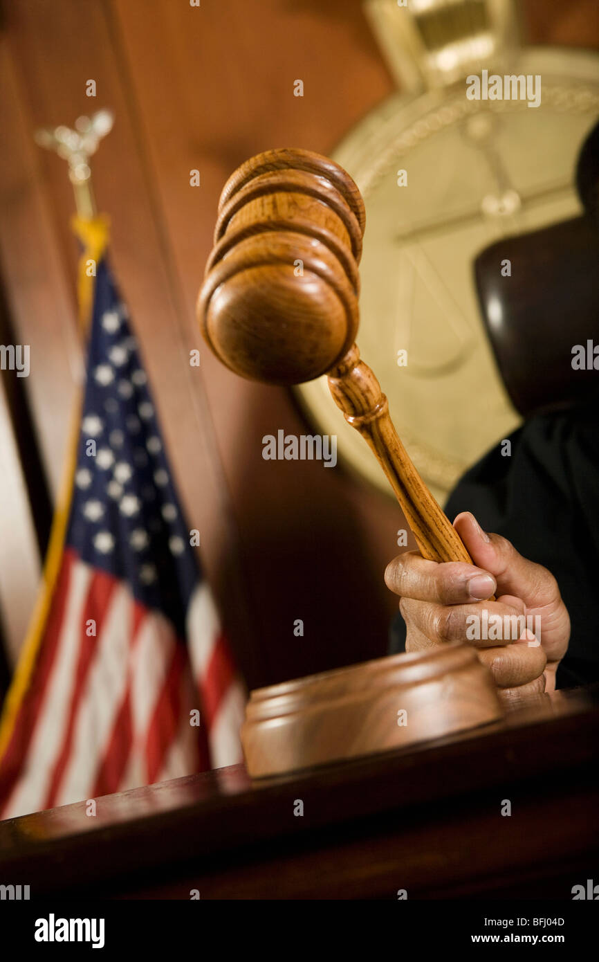 Gavel in judge's hand Stock Photo - Alamy