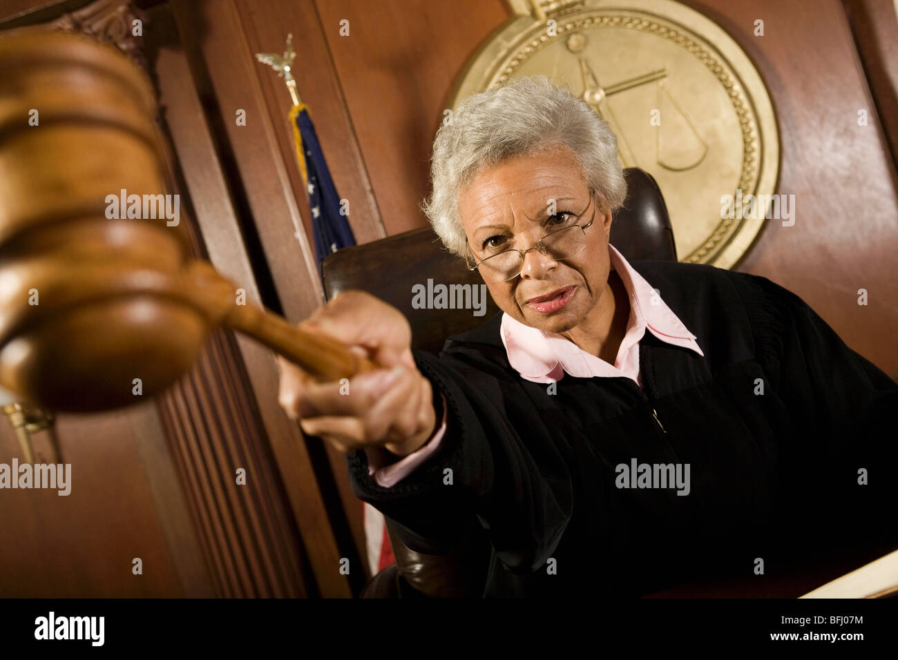 Female judge holding hammer in court Stock Photo - Alamy