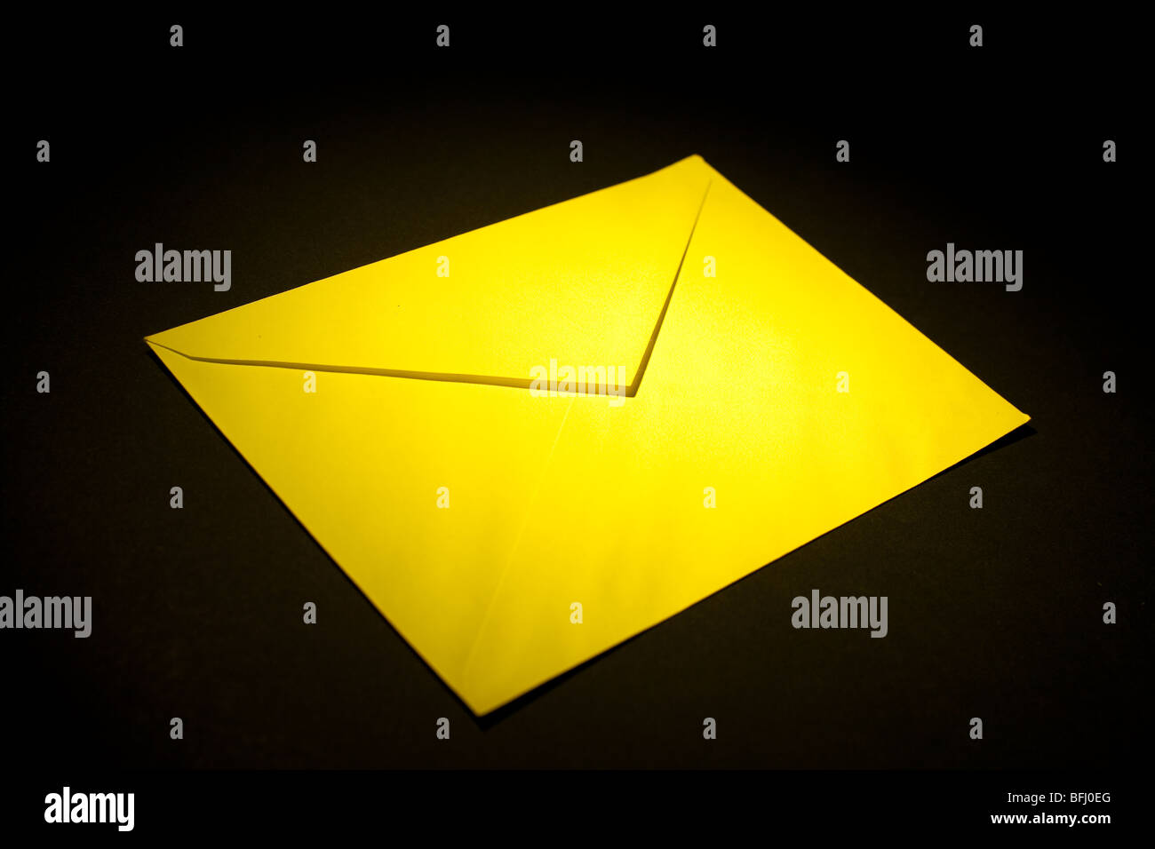 closed envelope with yellow spot light on black background Stock Photo ...