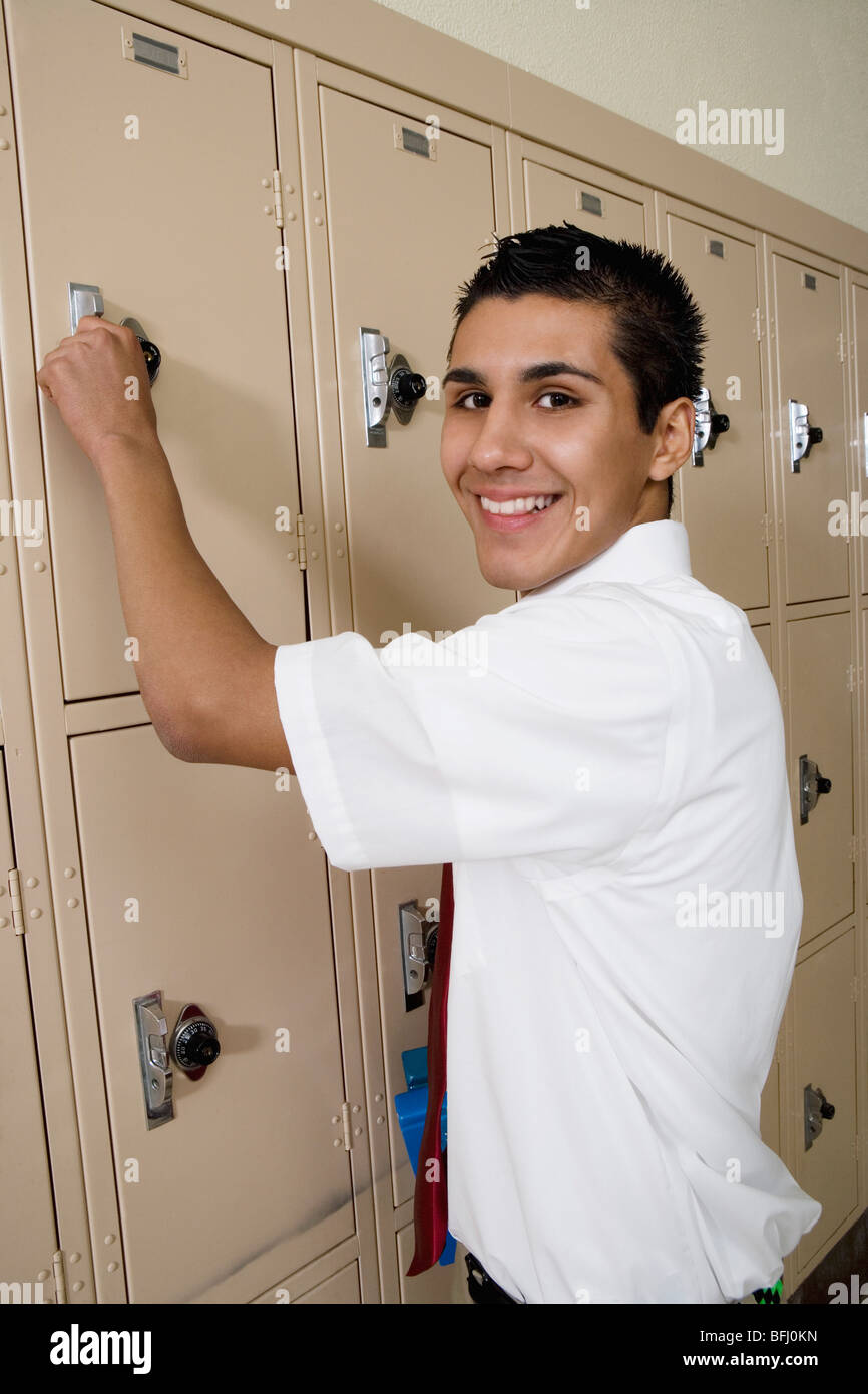 High School Boy Opening Locker Stock Photo - Alamy