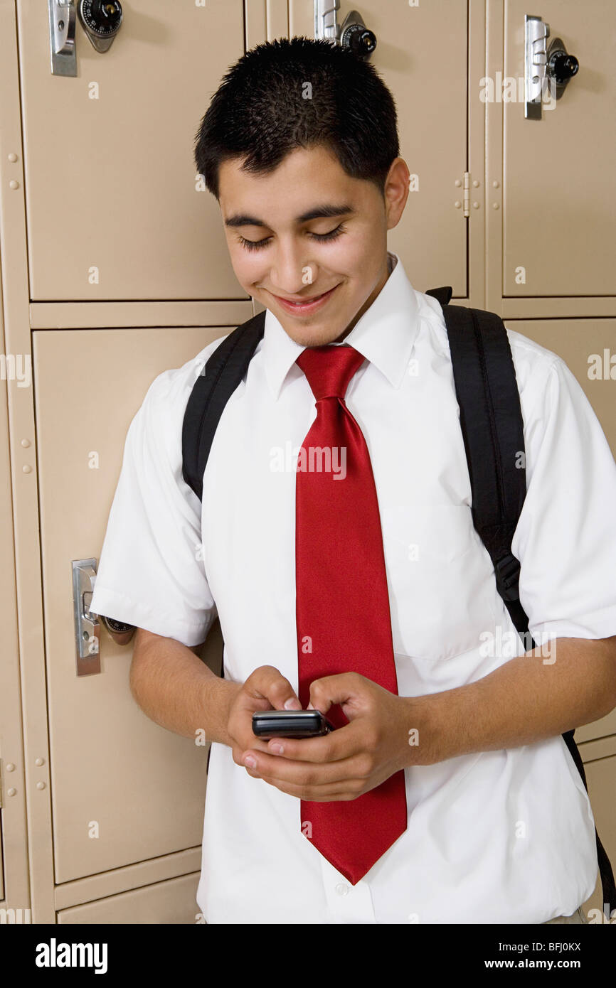 High School Boy Text Messaging by School Lockers Stock Photo - Alamy