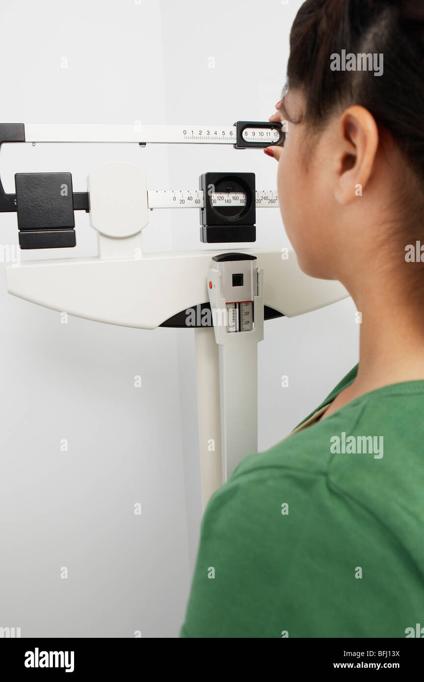 Girl using measuring scales in hospital Stock Photo - Alamy