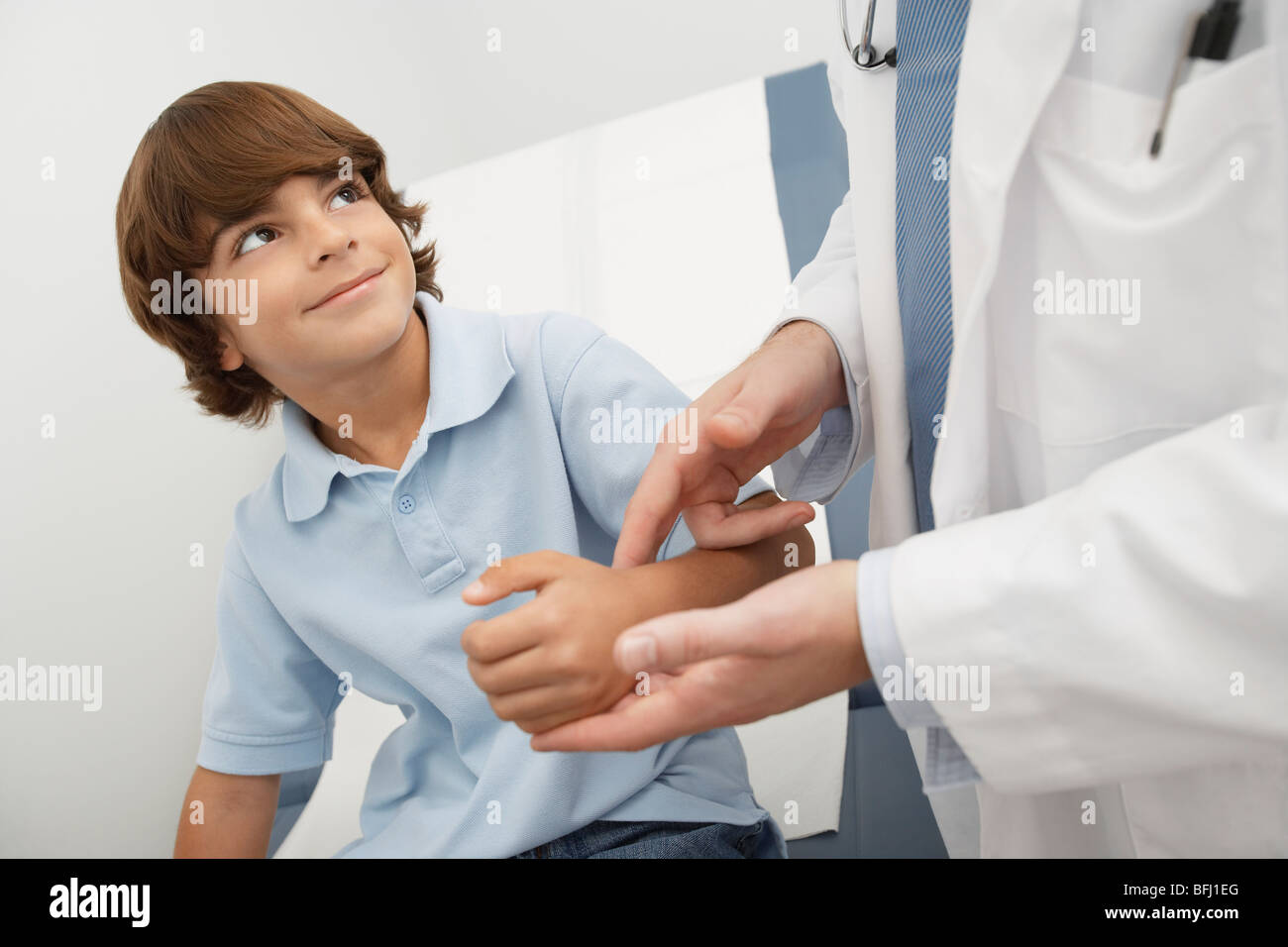Doctor checking boys pulse Stock Photo - Alamy Doctor checking boys pulse Stock Photo - Alamy