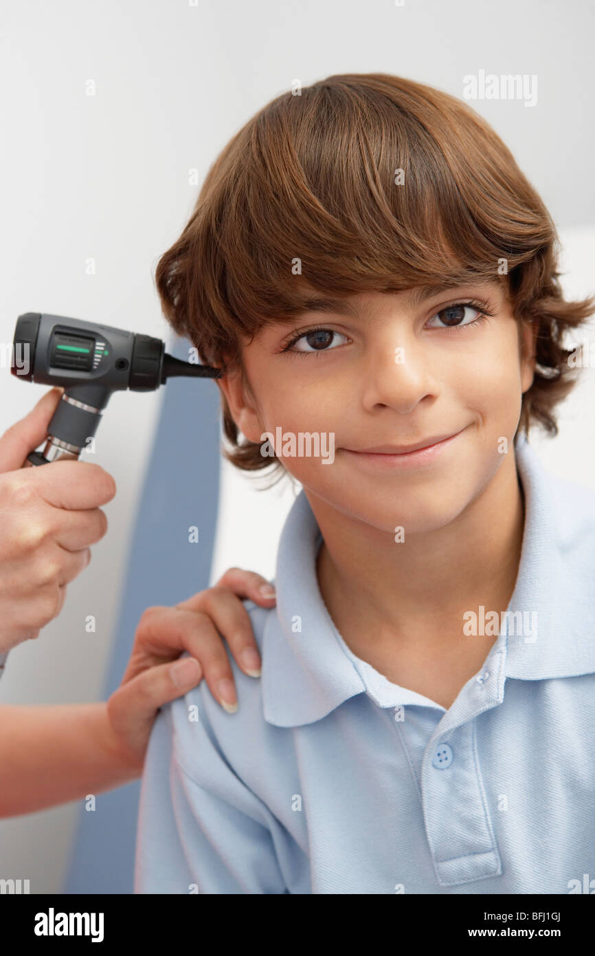 Boy having his ear examined Stock Photo - Alamy