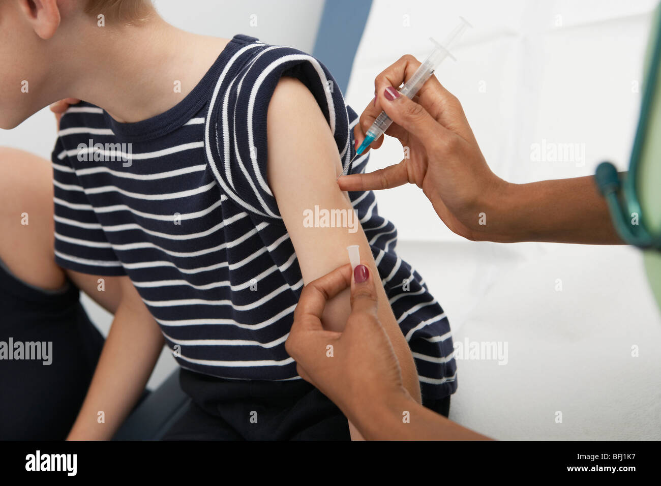 Boy receiving injection,close up view Stock Photo - Alamy