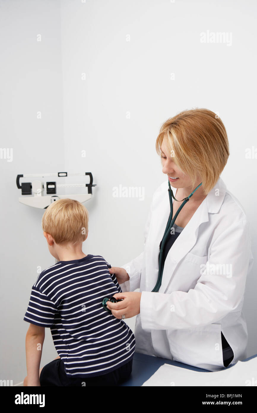 Boy being examining doctor stethoscope hi-res stock photography and ...