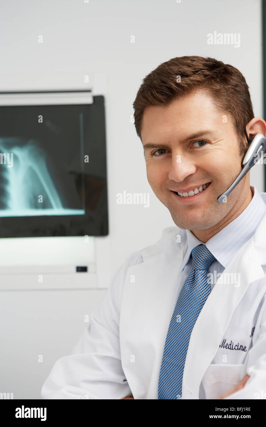 Doctor wearing earpiece in hospital,portrait Stock Photo - Alamy