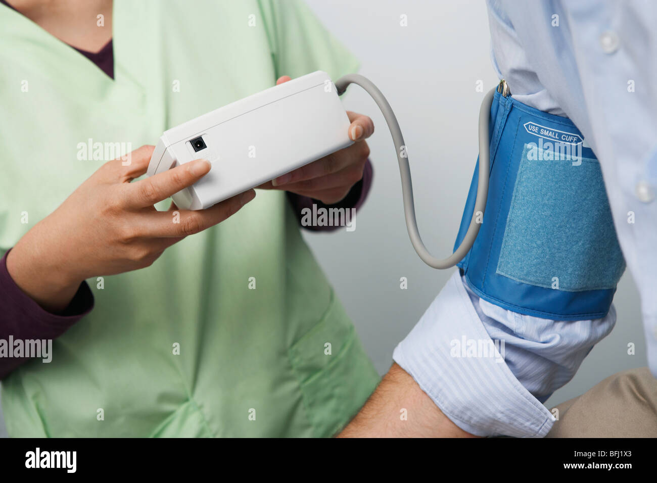 Doctor checking patients blood pressure,close-up Stock Photo - Alamy