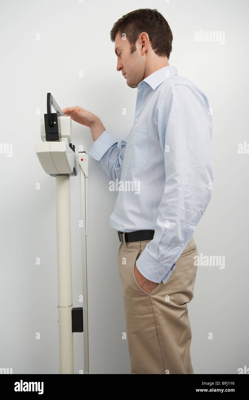 Man standing on weighing scales in hospital Stock Photo - Alamy